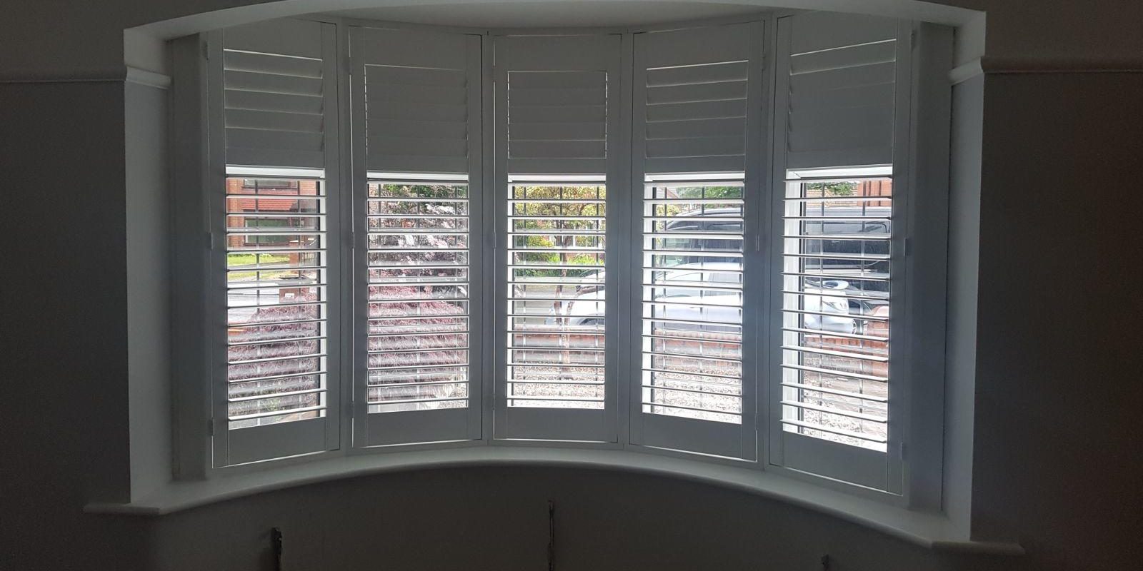 5 panel curved bay window installation | Absolute Shutters