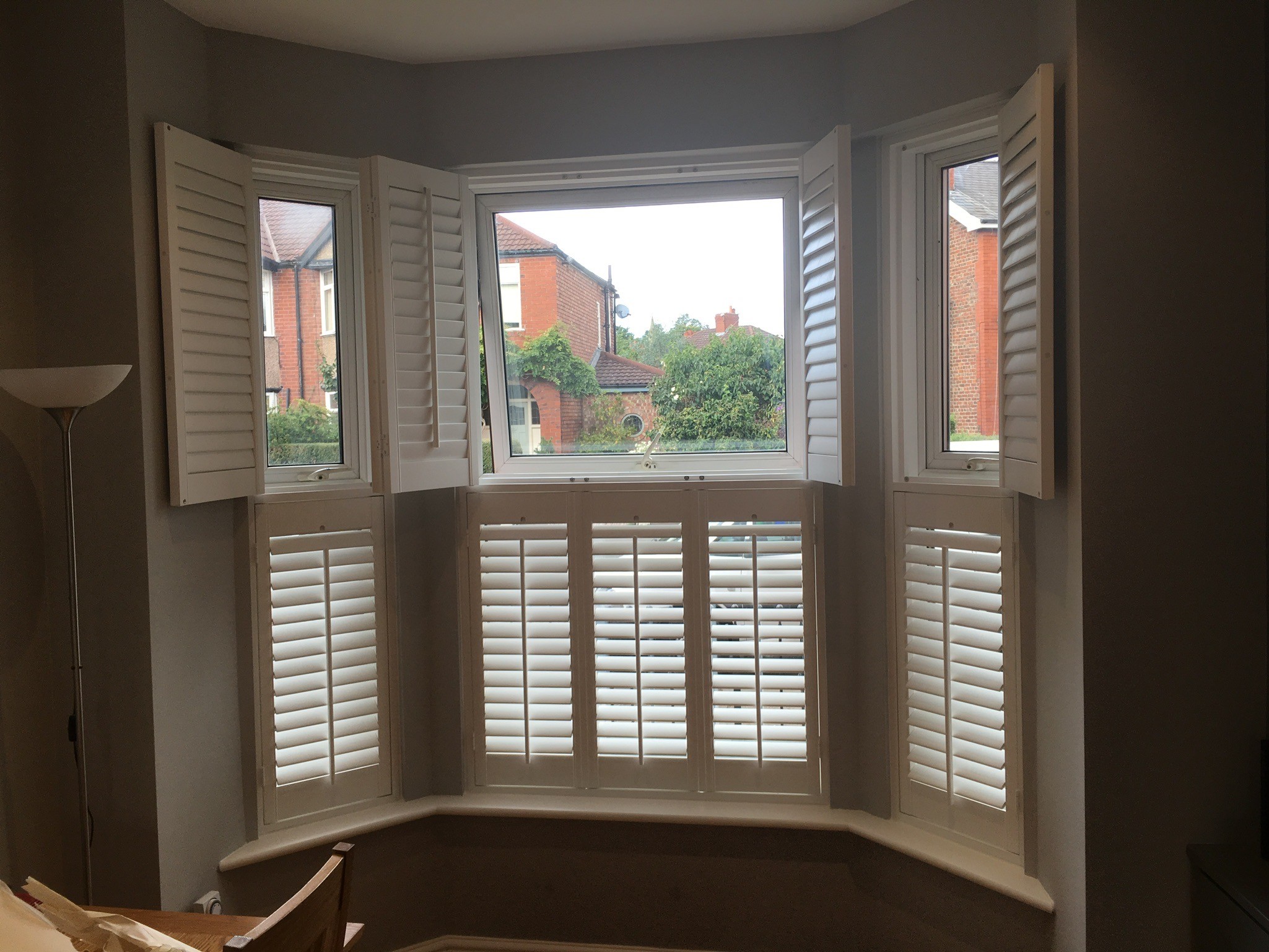 Bay window fitted with hardwood poplar, tier on tier planation shutters in Manchester | Absolute ...